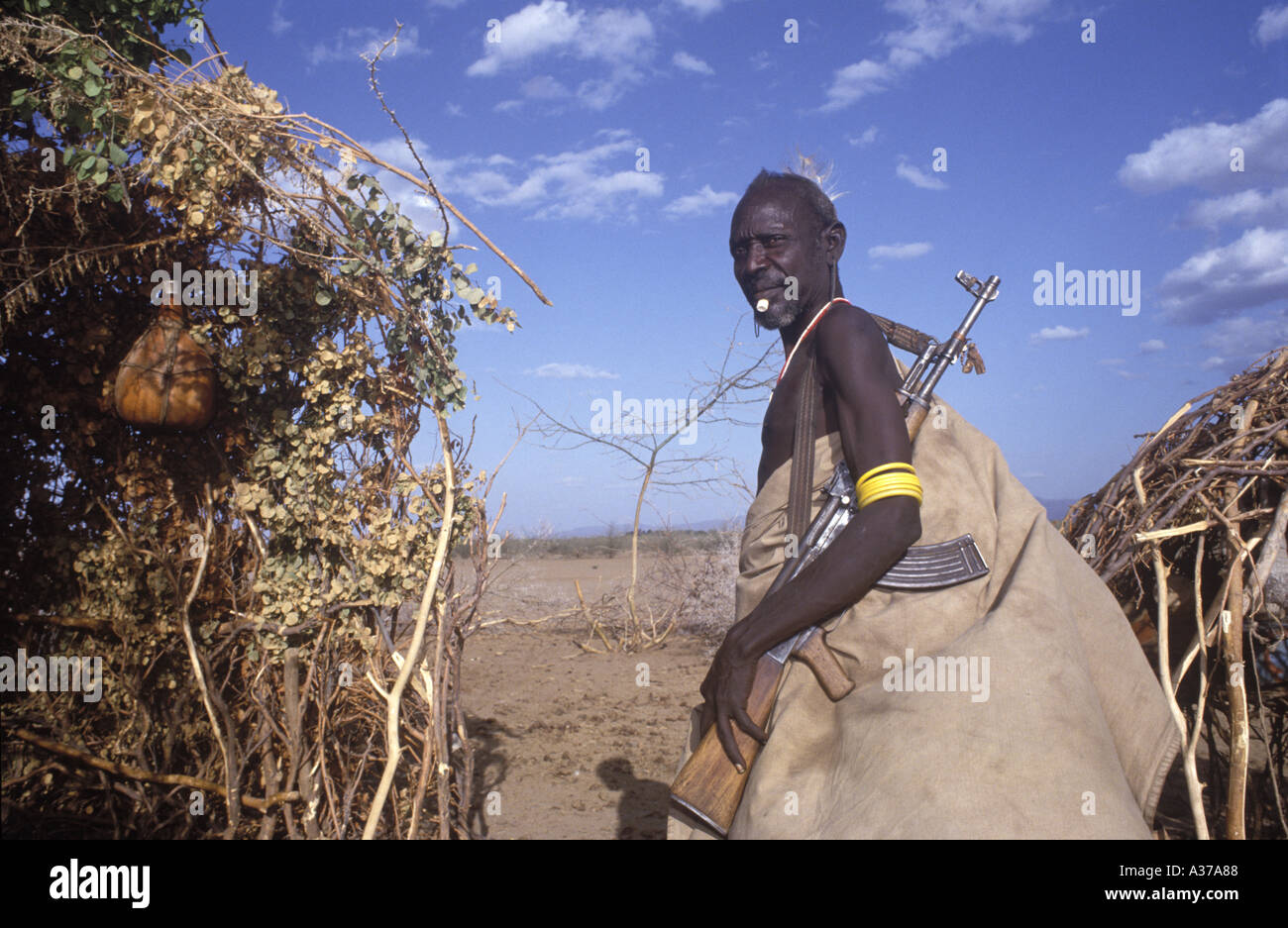 A Turkana man and AK 47 which he uses for protecting his livestock in a ...
