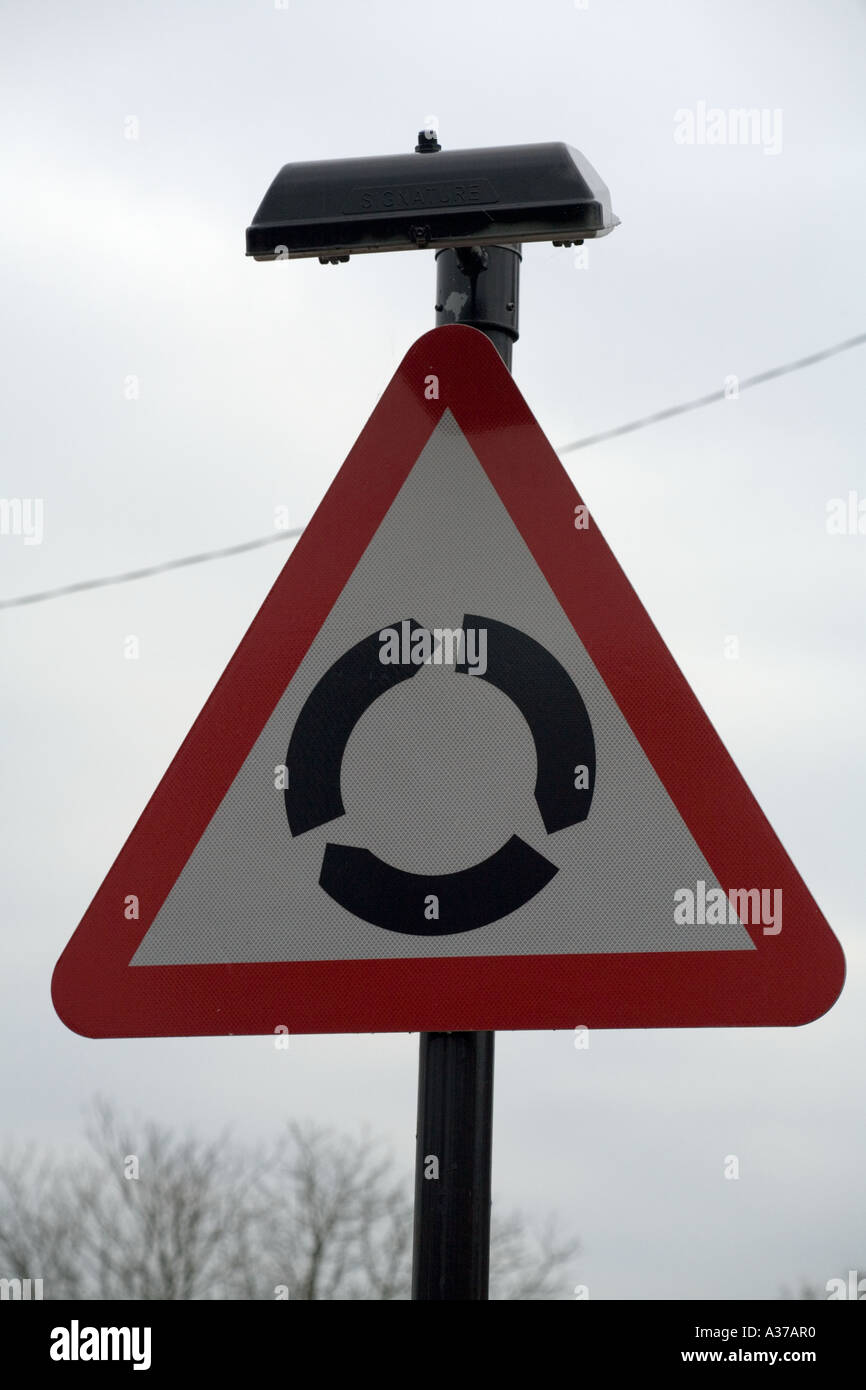 traingle warning road sign off a mini round about ahead sky in the back ...