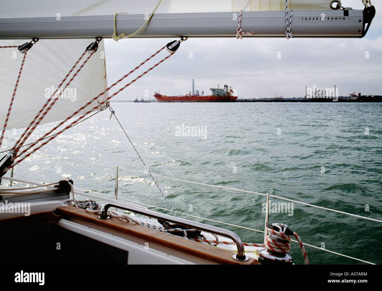 Tankers seen from yacht through sails Stock Photo - Alamy