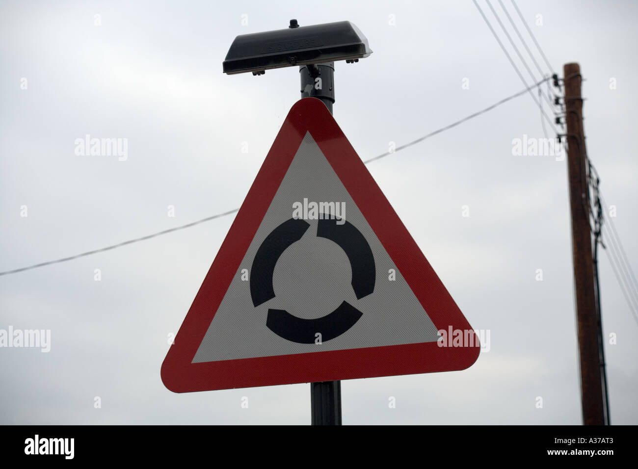 traingle warning road sign off a mini round about ahead sky in the back ...