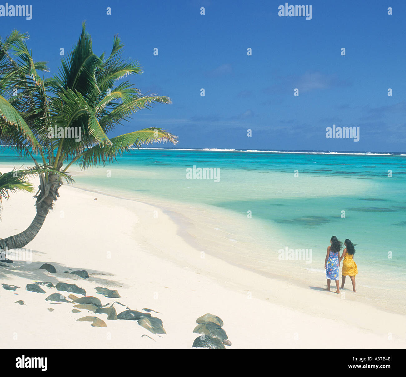 Two Polynesian women in sarongs on Rarotonga beach in Cook Islands ...