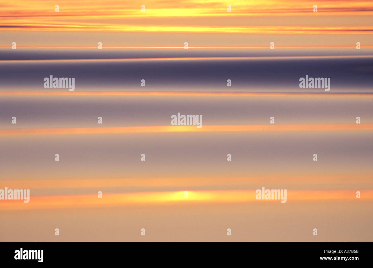 Sun reflecting off waves crossing glassy water Stock Photo - Alamy