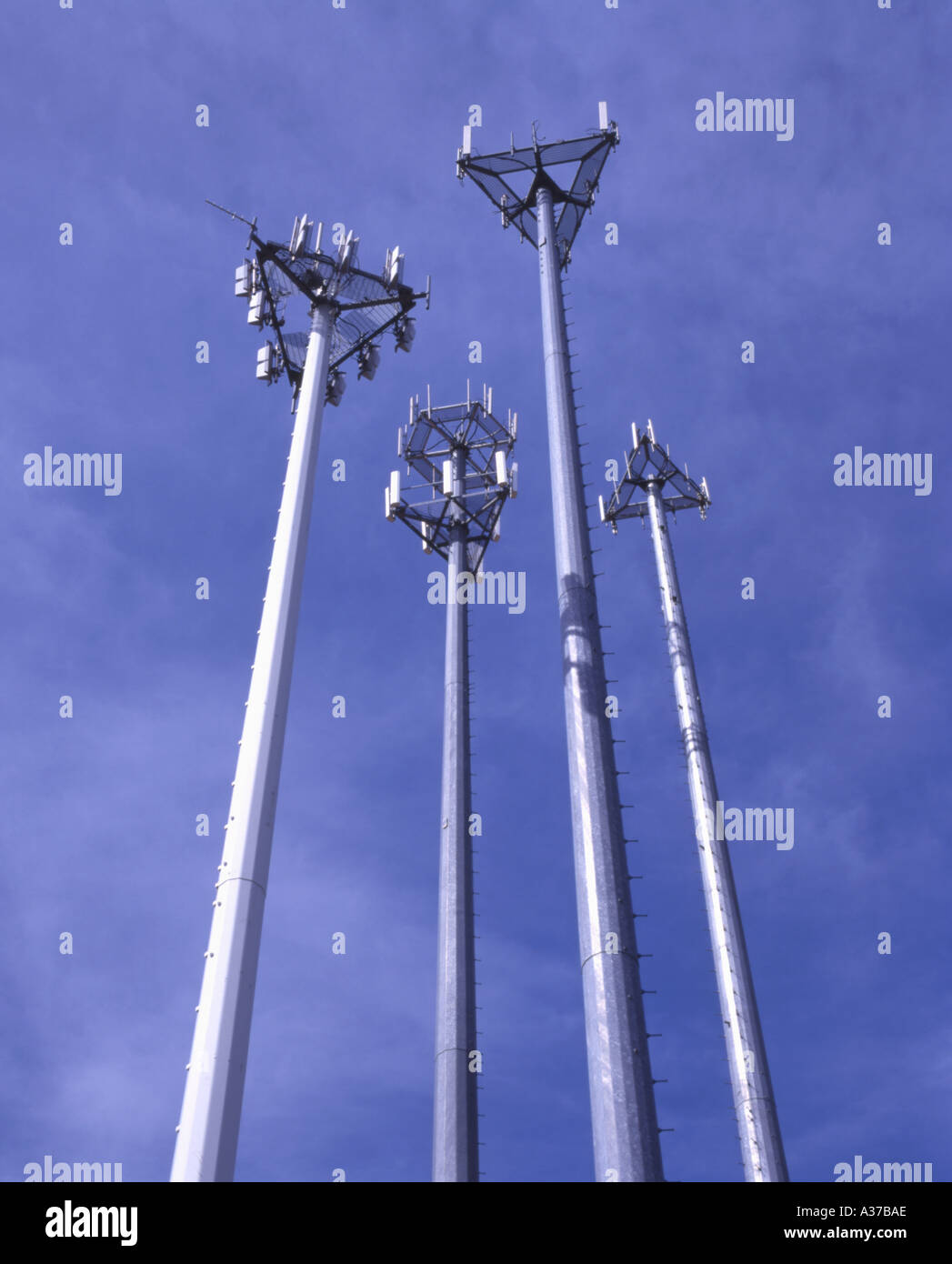 Group of Telecommunication Towers against Blue Sky Stock Photo - Alamy
