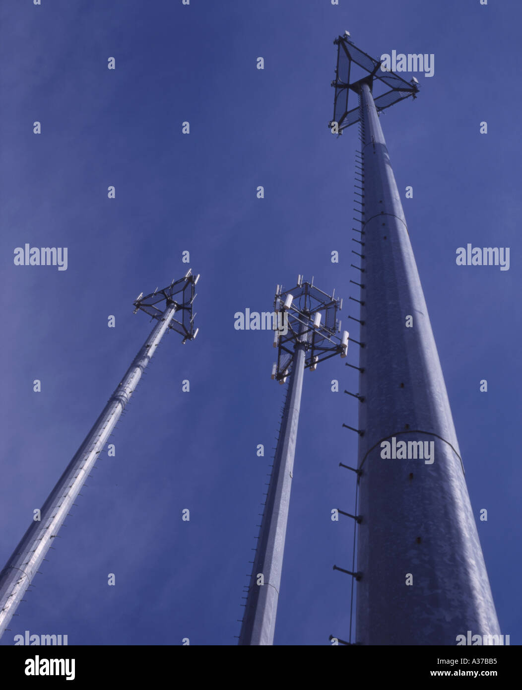 Trio Of Cell Towers under Blue Sky Stock Photo - Alamy