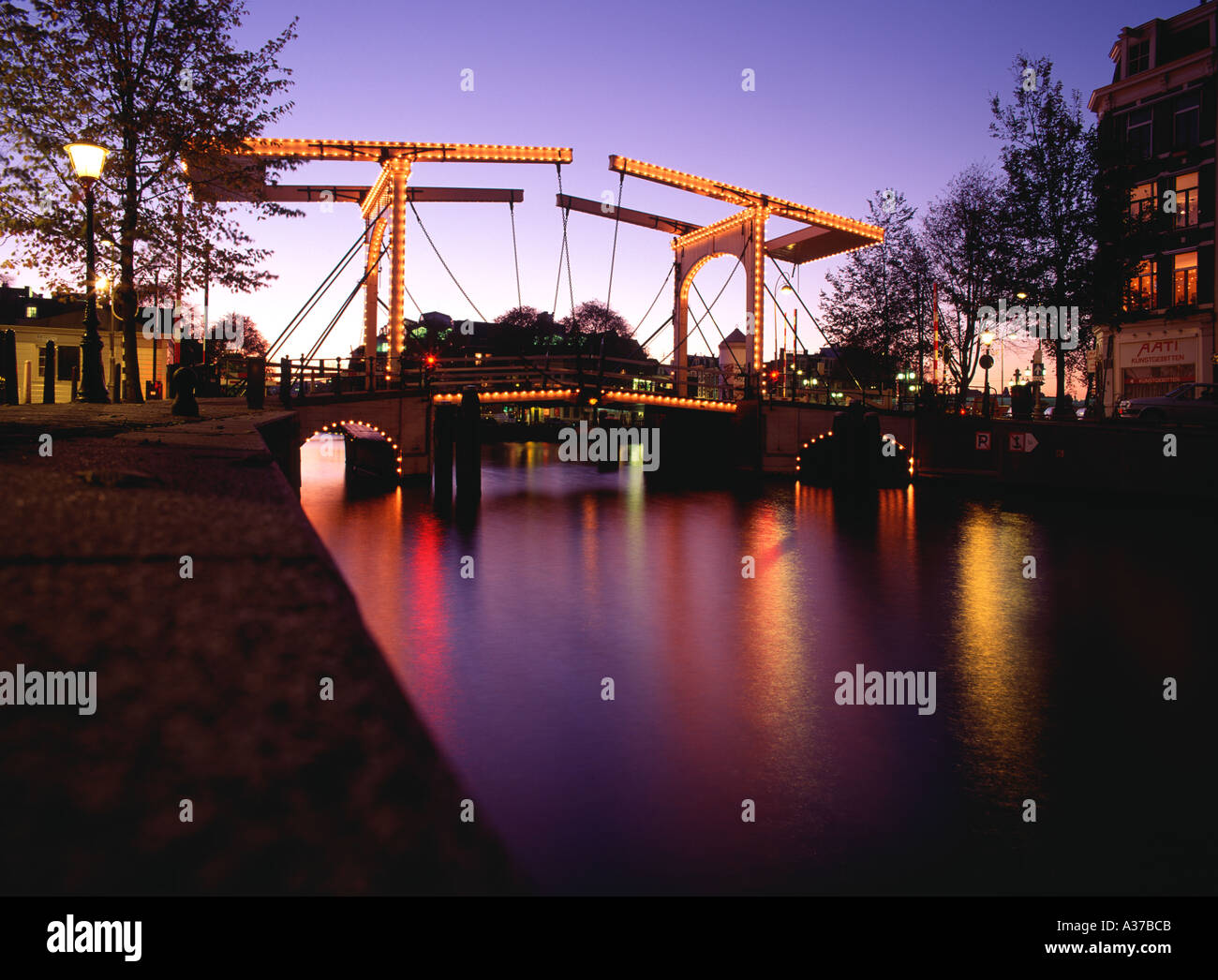 Traditional lifting bridge crossing Nieuwe Herengracht near River ...