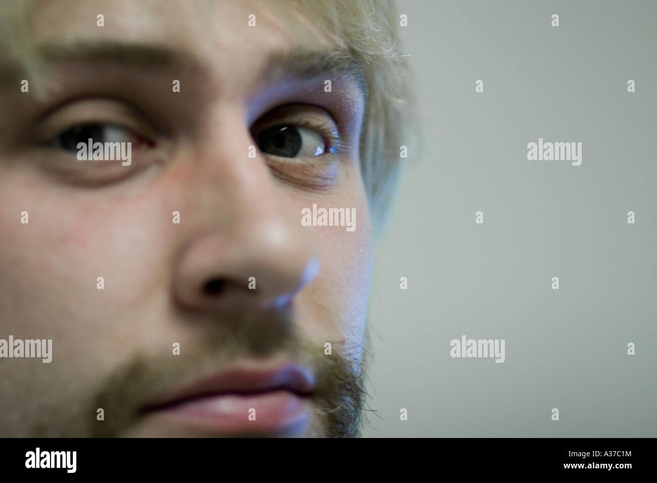 Young man looking at camera Stock Photo - Alamy
