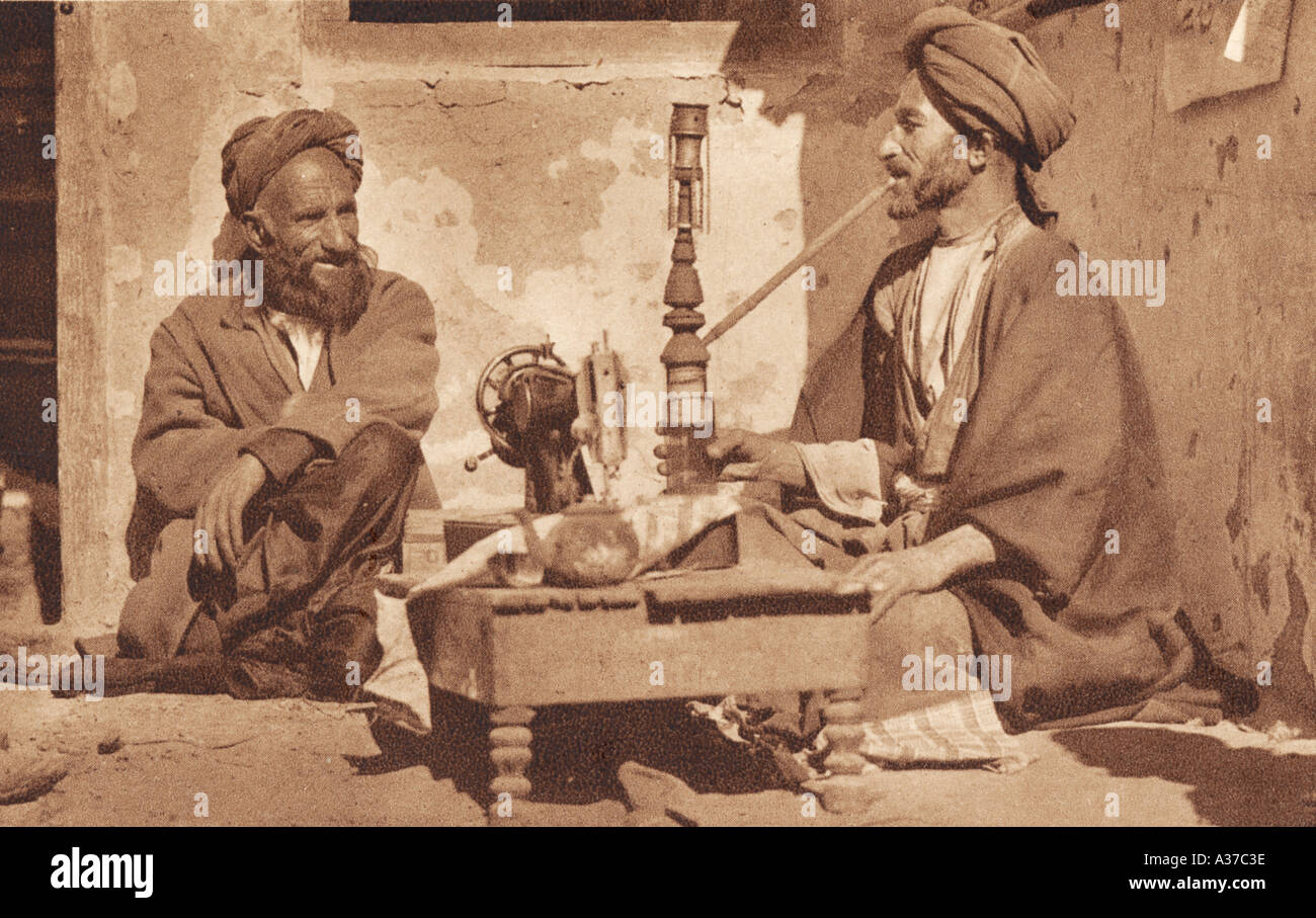 Persian tailor smoking a qalyan in the bazaar at Masjid I Sulaiman ...
