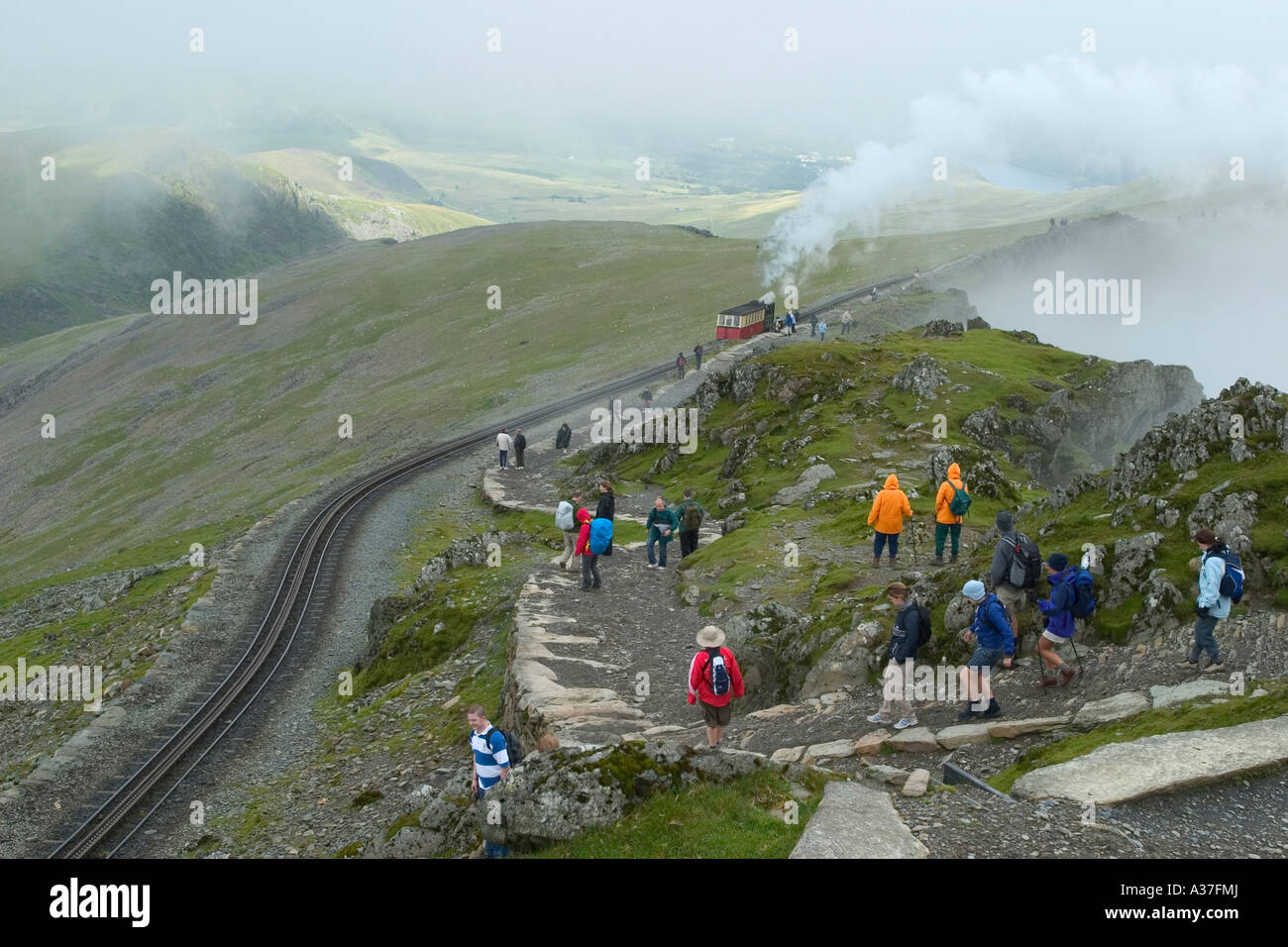 A steam train approaches the summit of Snowdon, the highest mountain in ...