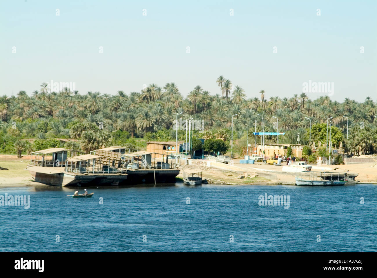 Sailing to Edfu from Kom Ombo Nile River coastline port boats people ...