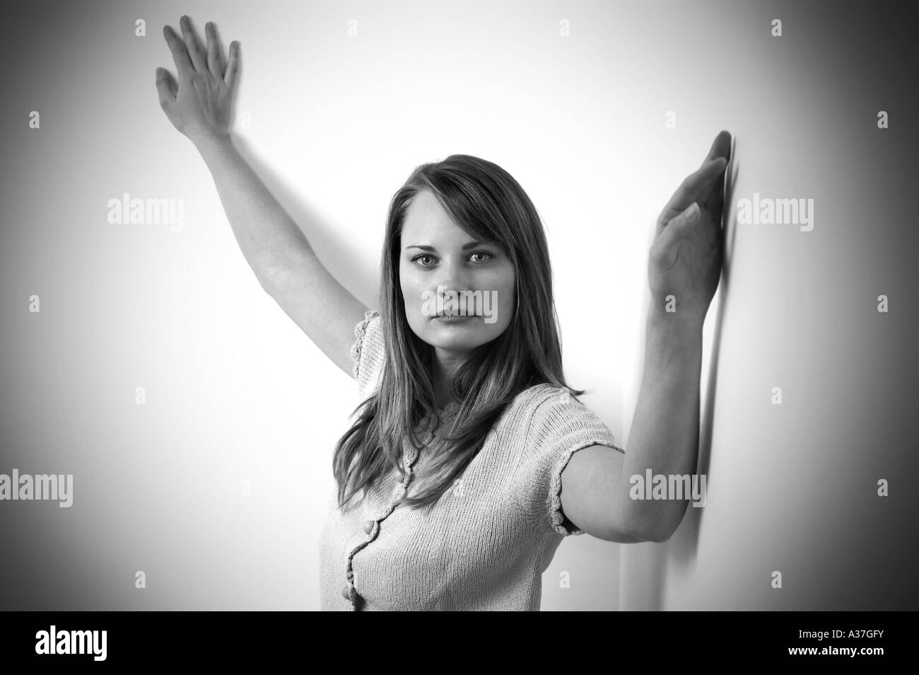 Beautiful woman standing in a corner with hands up on the walls Stock ...