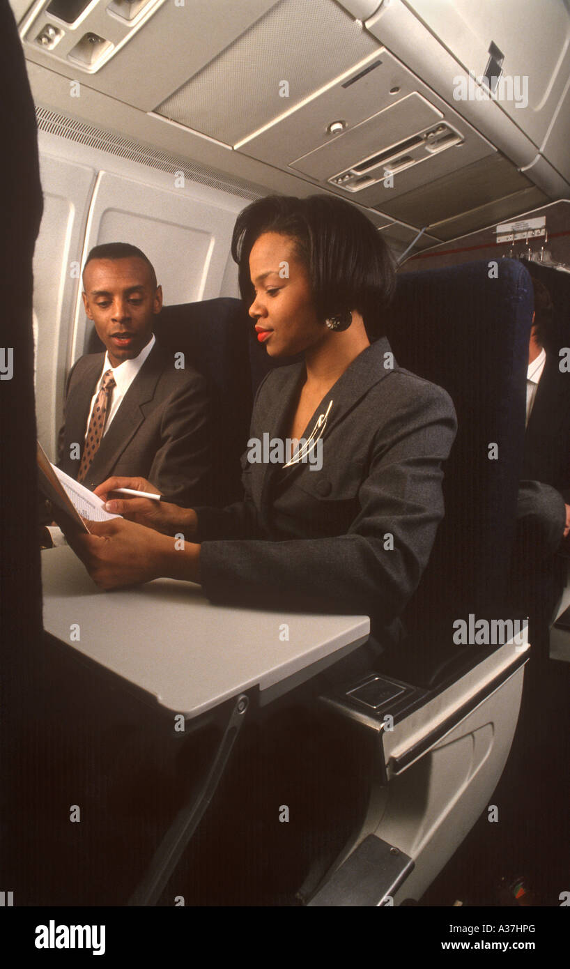 Executives on airplane in flight Stock Photo - Alamy