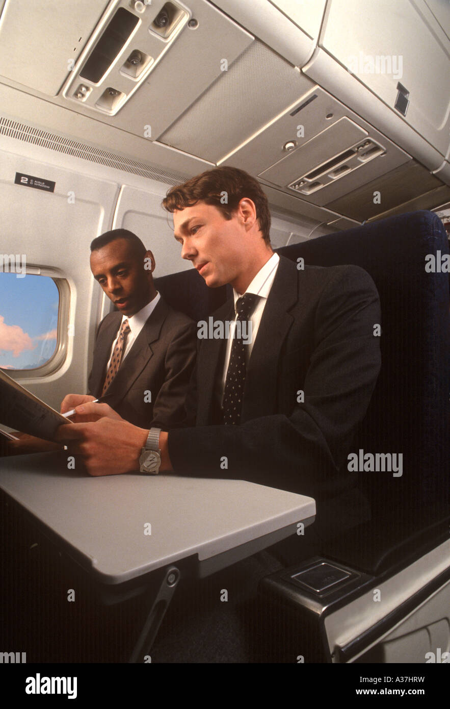 Businessmen on commercial flight Stock Photo - Alamy