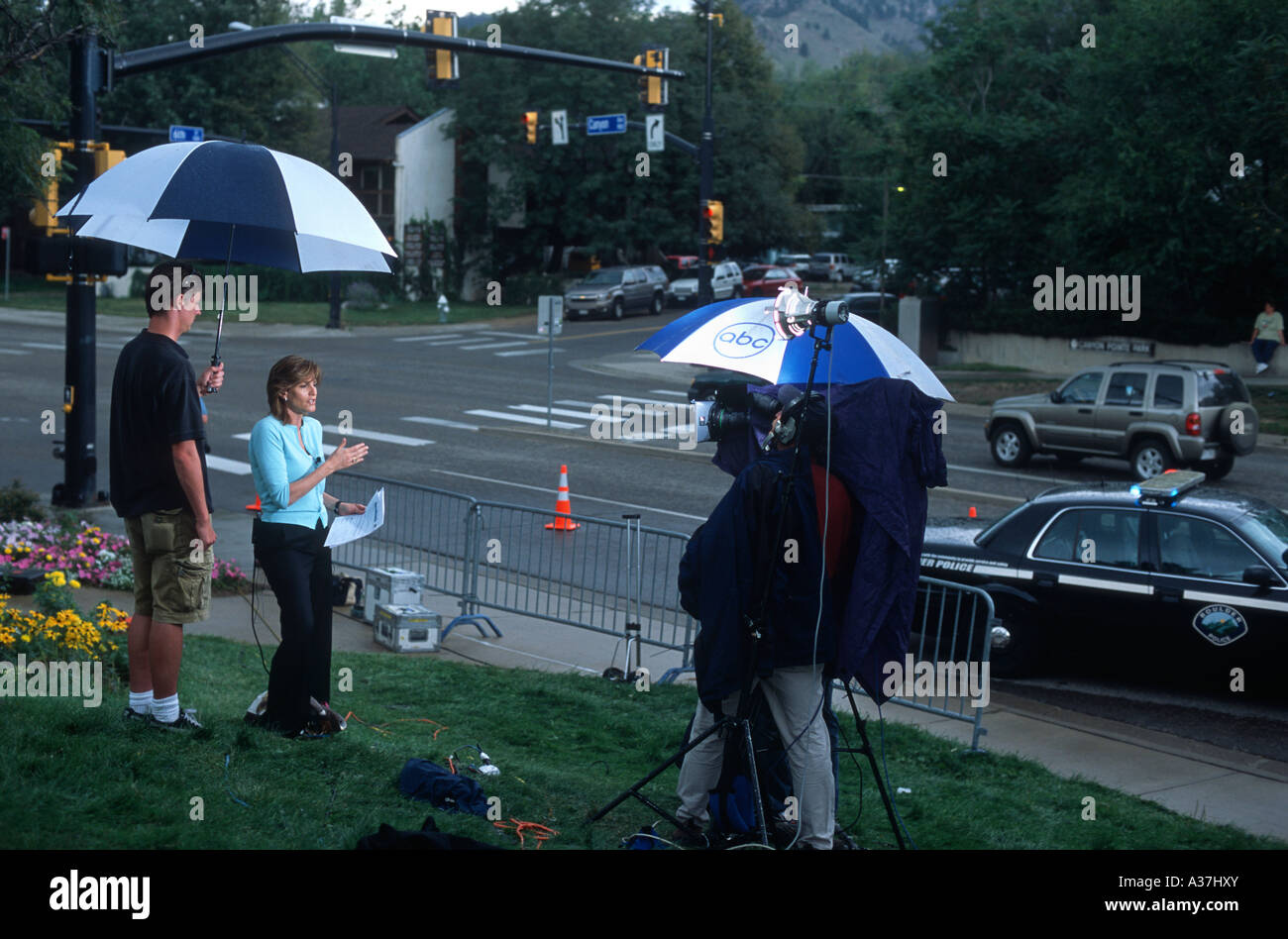 Television news reporter an dcrew filing story in the rain Stock Photo ...