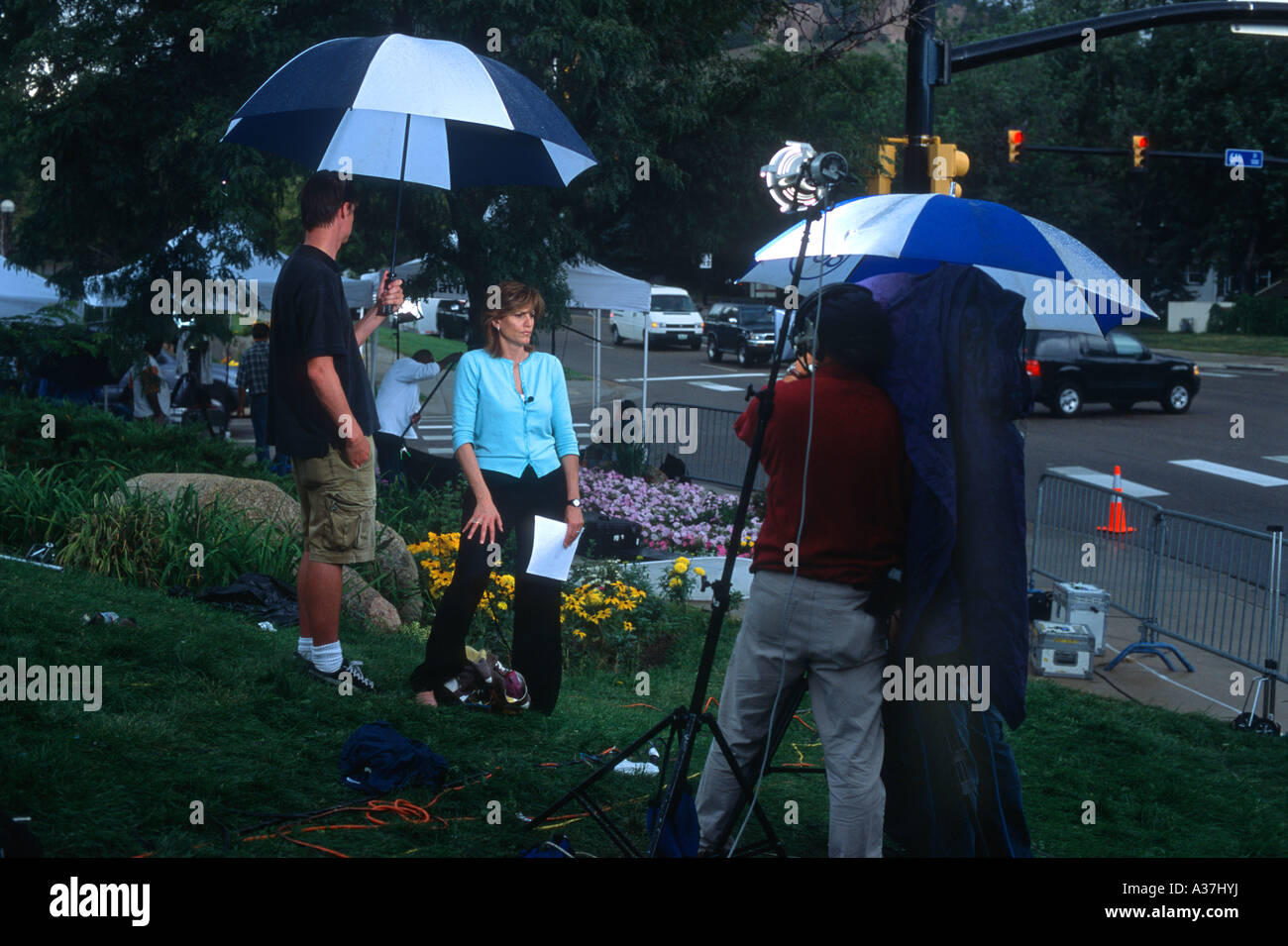 Television news reporter an dcrew filing story in the rain Stock Photo ...