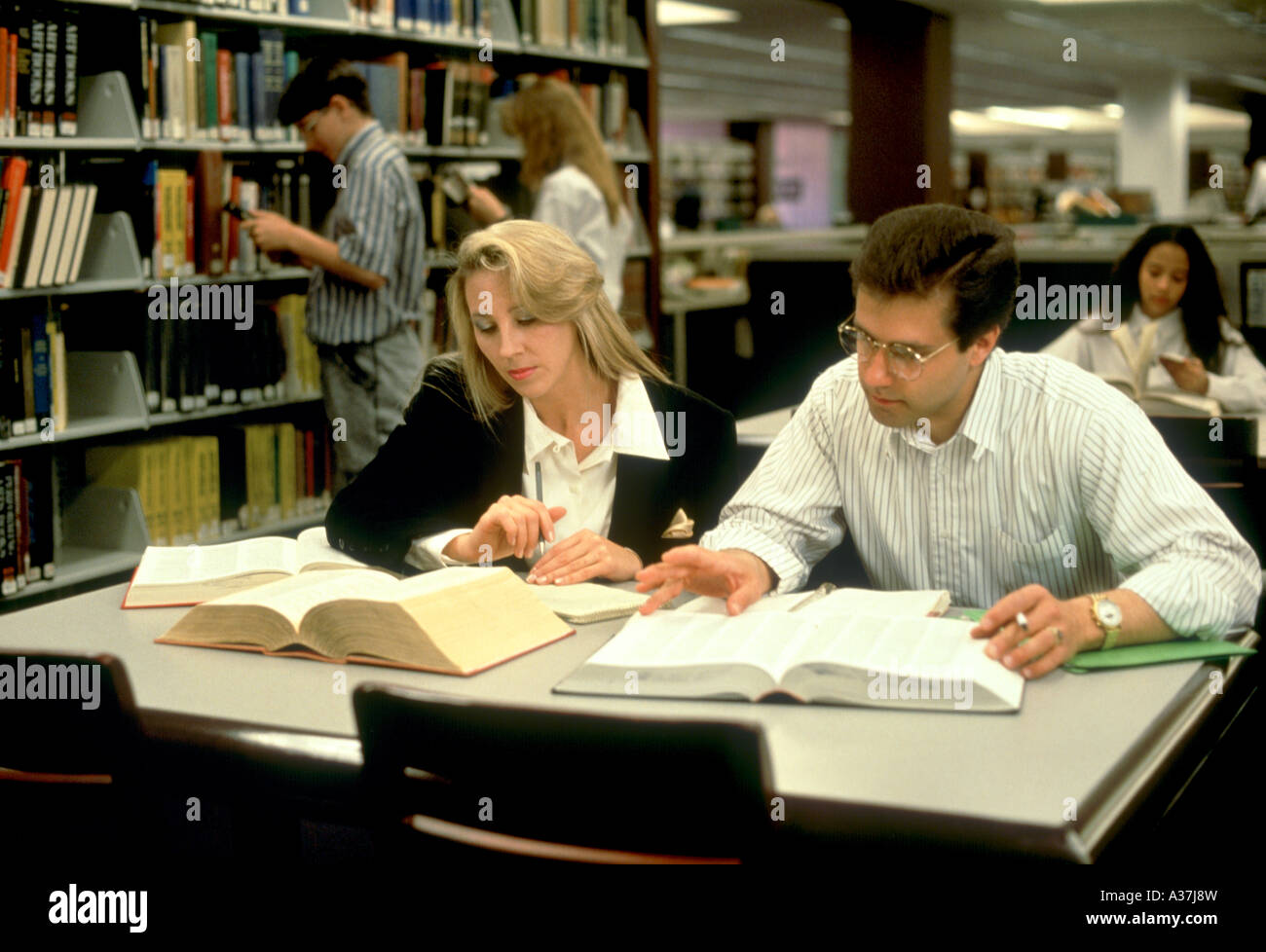 Adults in library Stock Photo - Alamy