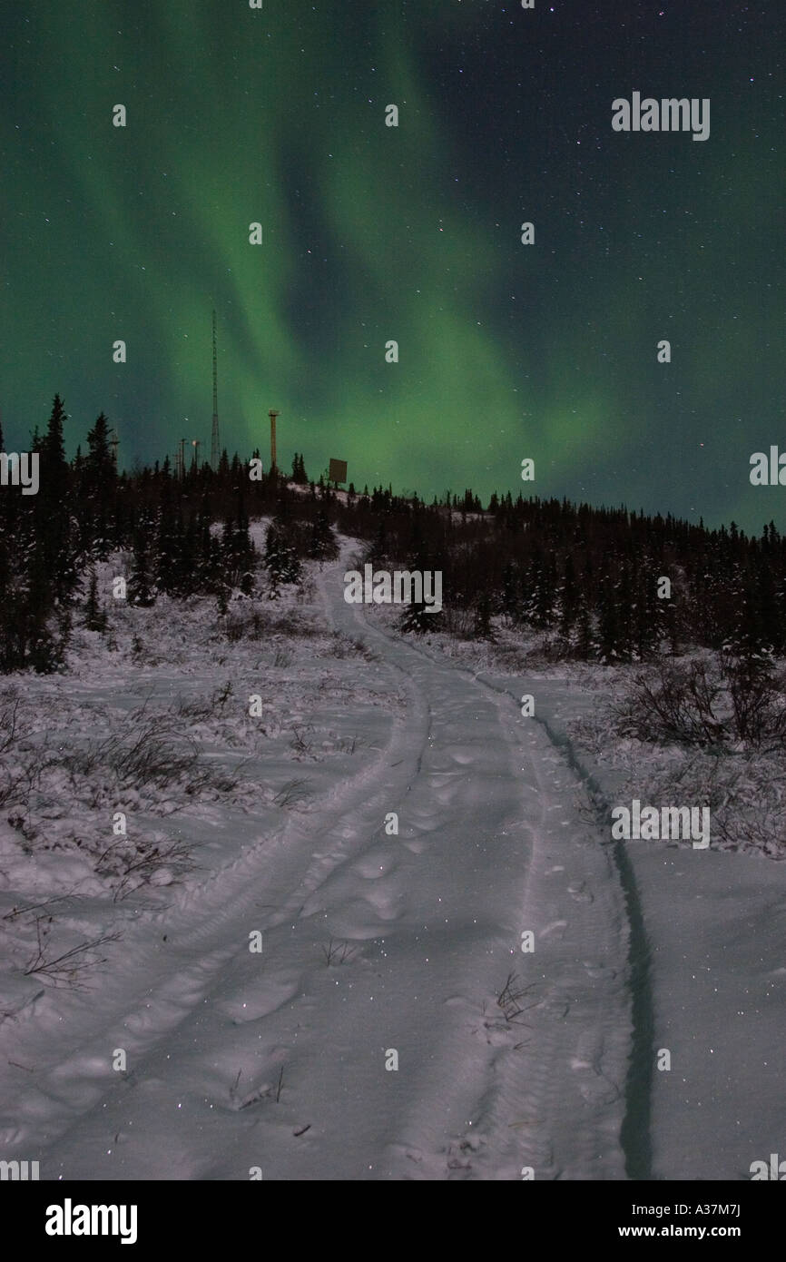 Winter road to the antenna complex in winter sky filled with moonlight ...