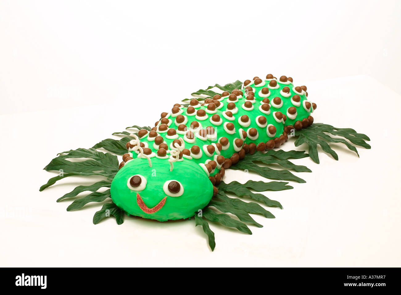 Green cake in shape of centipede caterpiller Stock Photo - Alamy