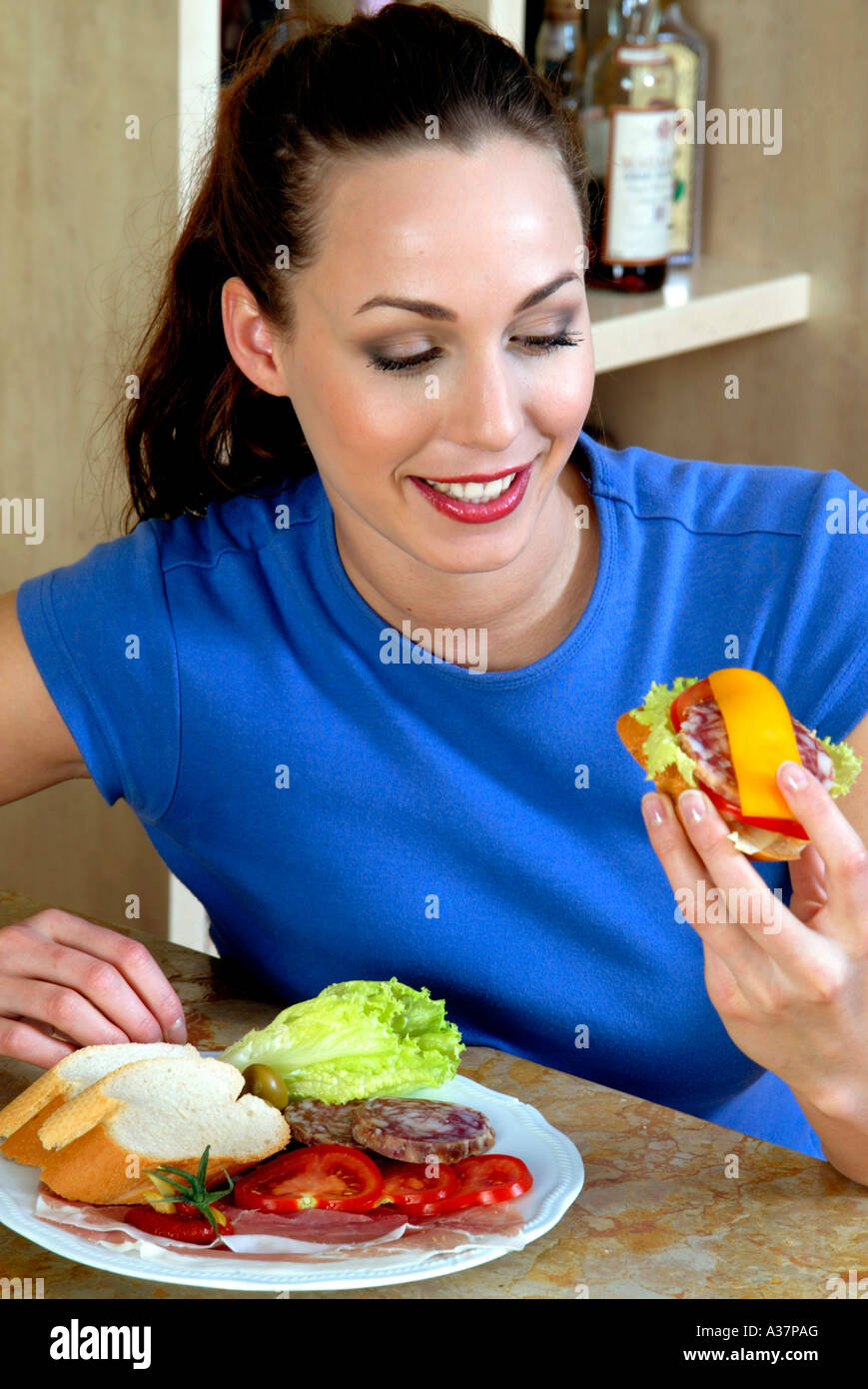 Frau beim Essen, Girl Young Woman Eating Sandwiched Baguette Starter ...