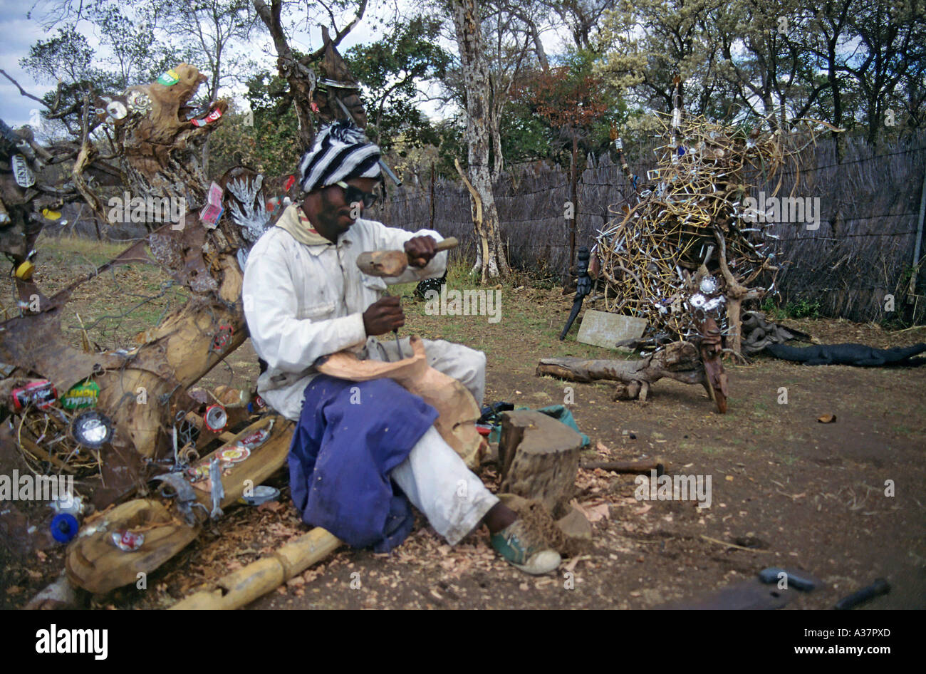 Artisan carving wood for tourists in Shona village Great Zimbabwe ...