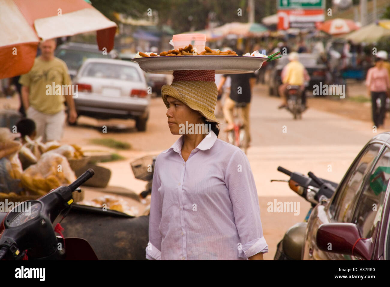 Woman carrying food on her head BALANCE, cambodia, siem reap, head ...