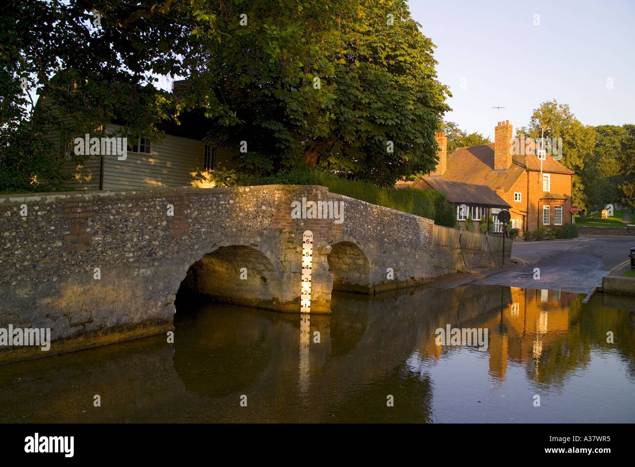 Late evening light on the ford and bridge over the river Darenth at ...