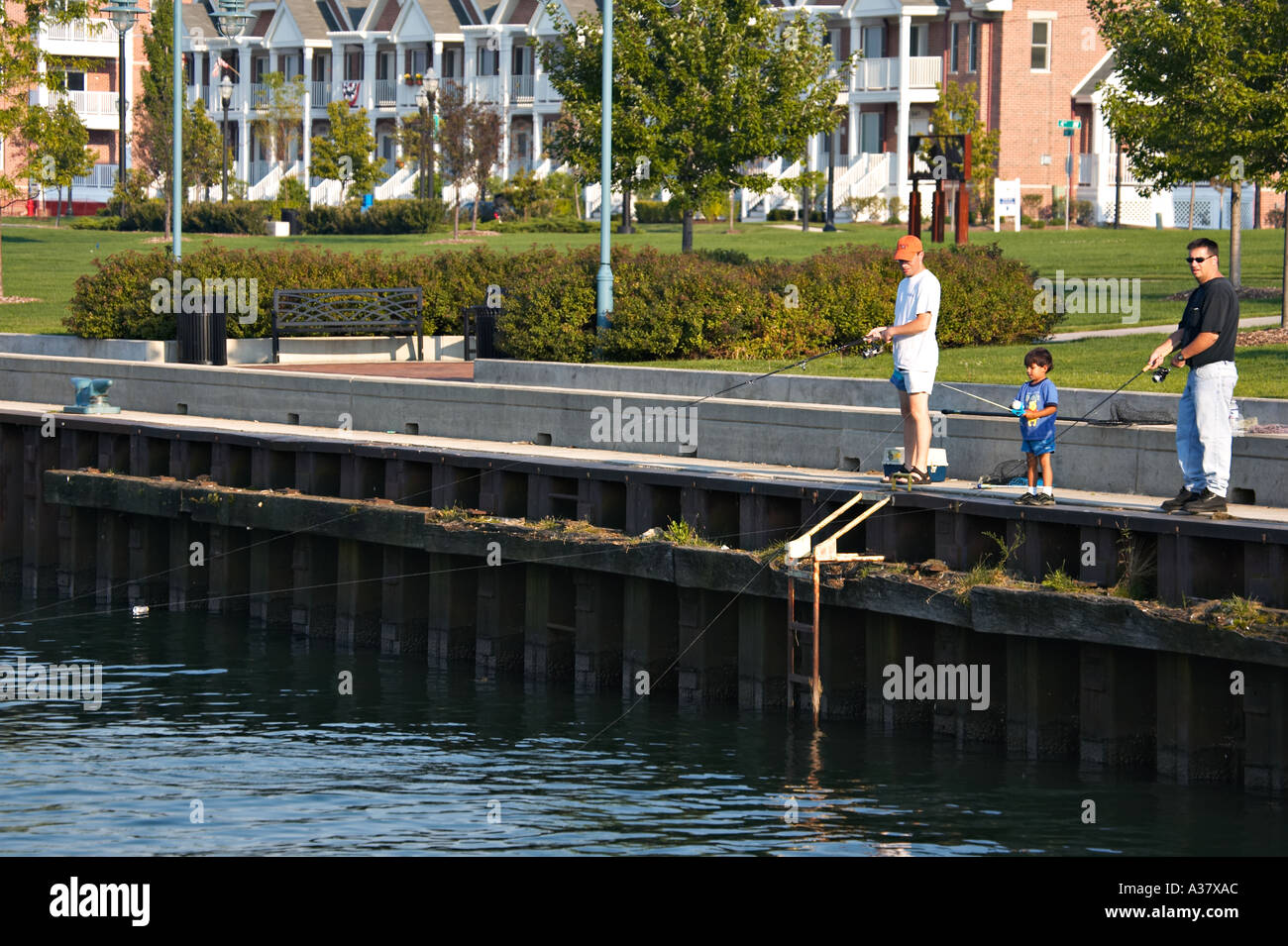 WISCONSIN Kenosha Two men and young boy fishing from pier housing ...
