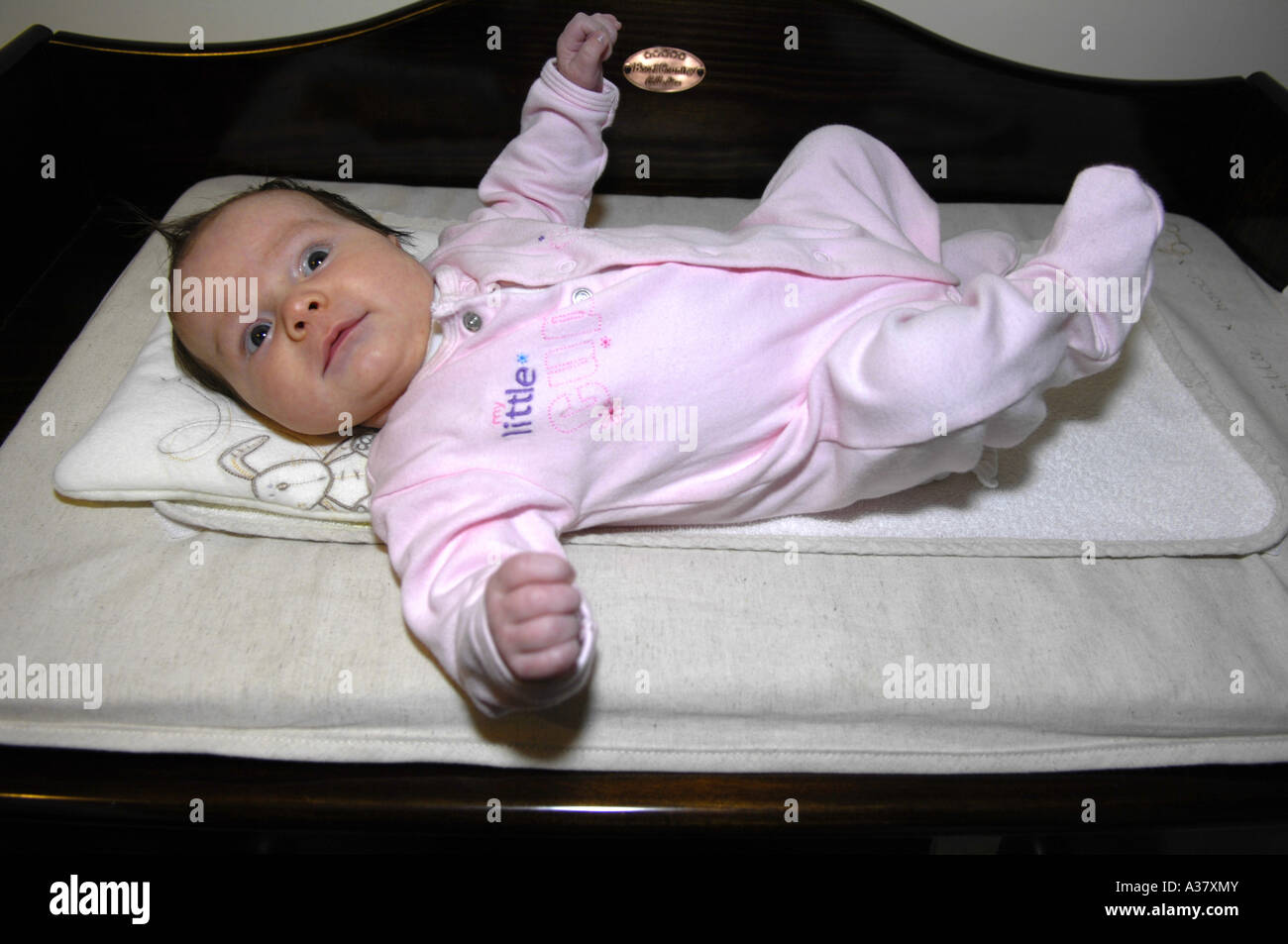 baby changing mat table sleepsuit pink girl two three months caucasian ...