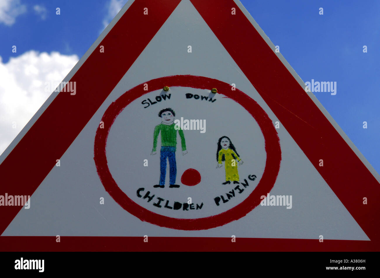 slow down red triangle road sign traffic calming measures blue sky ...