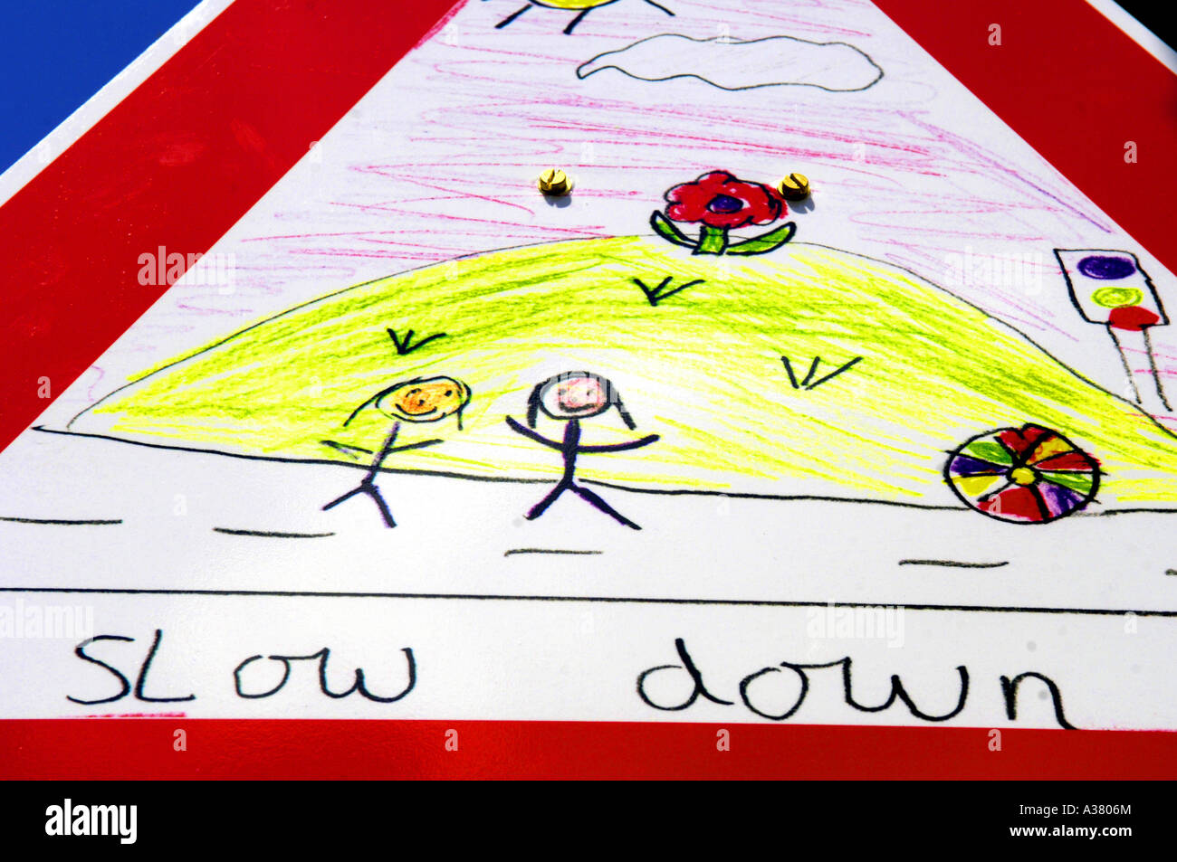 slow down red triangle road sign traffic calming measures blue sky ...