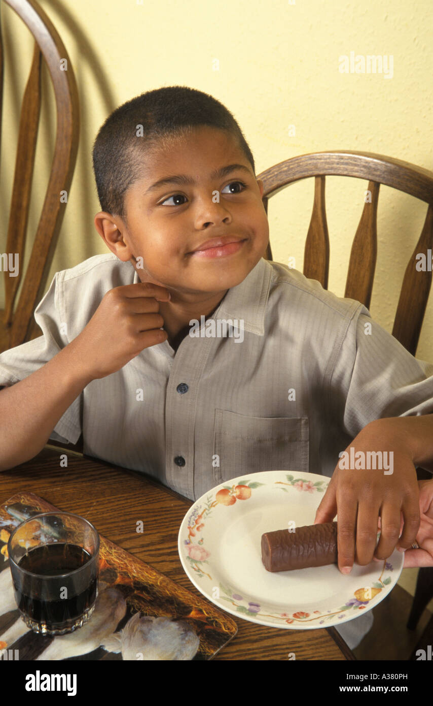 boy accepting a chocolate roll Stock Photo - Alamy