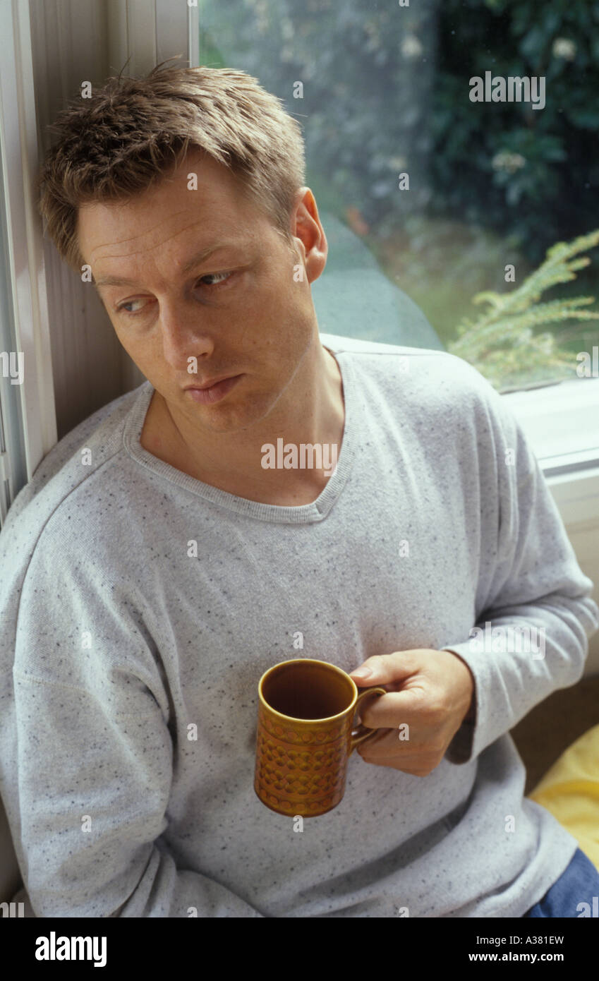 man looking miserable by the window Stock Photo - Alamy