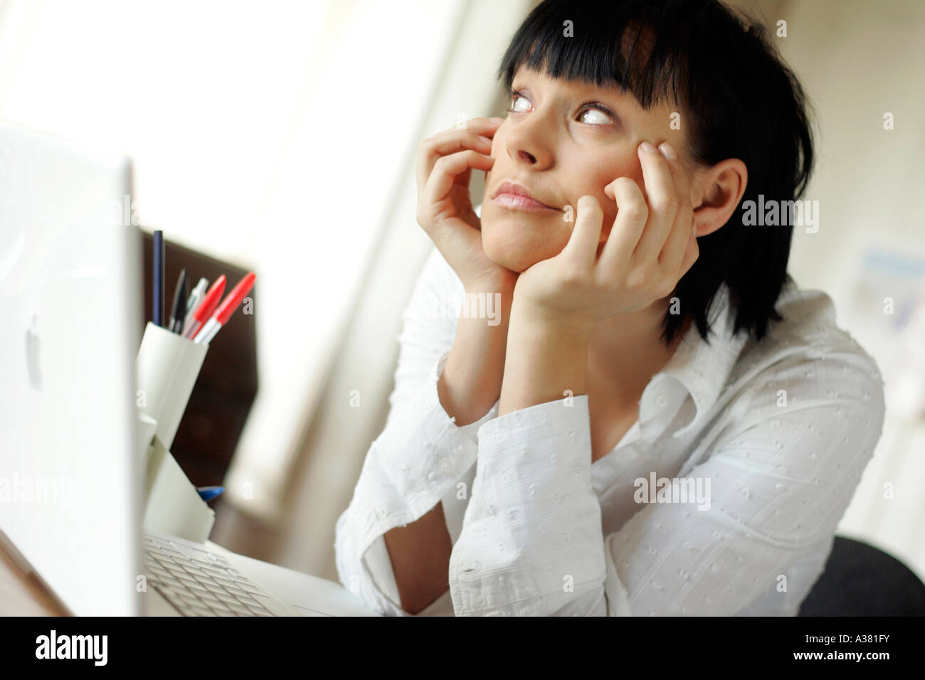 woman looking bored at work Stock Photo - Alamy