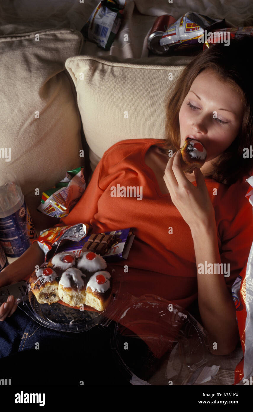 Woman binge eating watching Tv Stock Photo - Alamy
