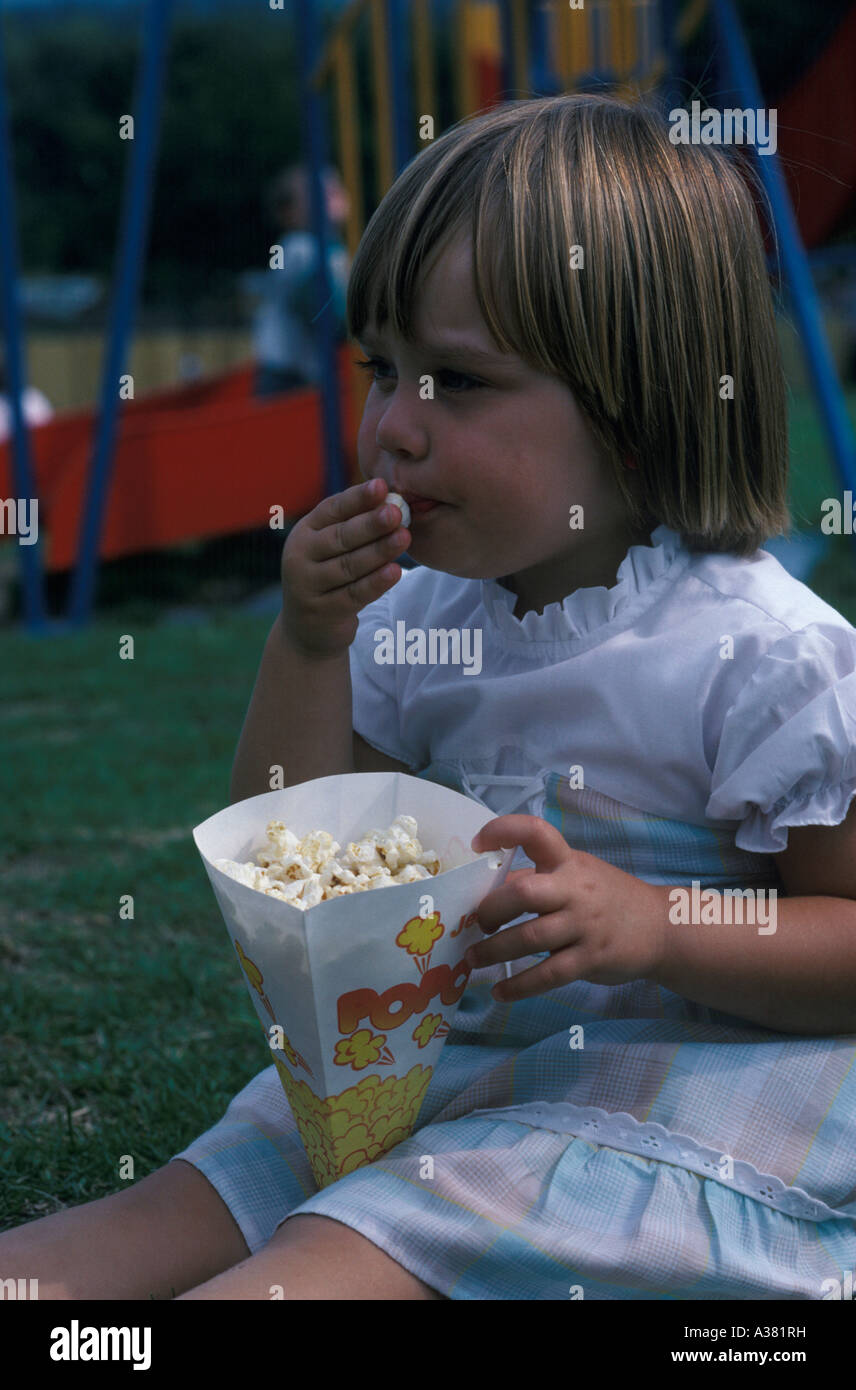 child eating popcorn out of a paper cornet Stock Photo - Alamy