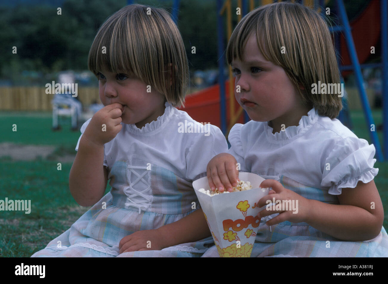 children eating popcorn out of a paper cornet Stock Photo - Alamy