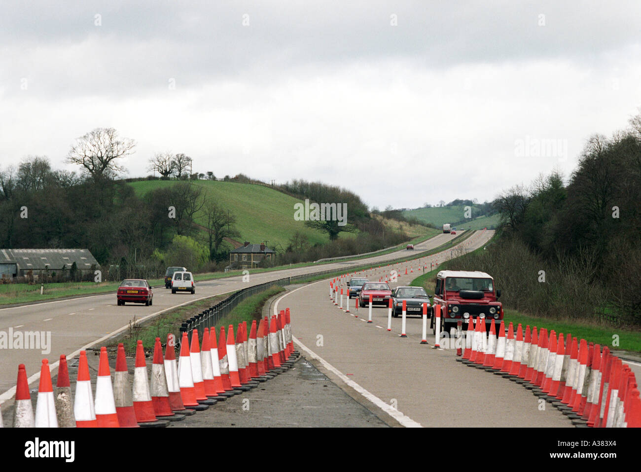 Traffic cones creating a contra flow on a highway Stock Photo - Alamy