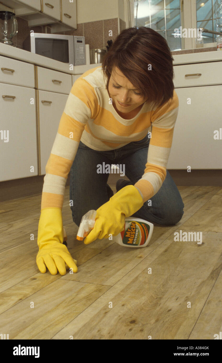 woman spraying a stain on the floor Stock Photo - Alamy