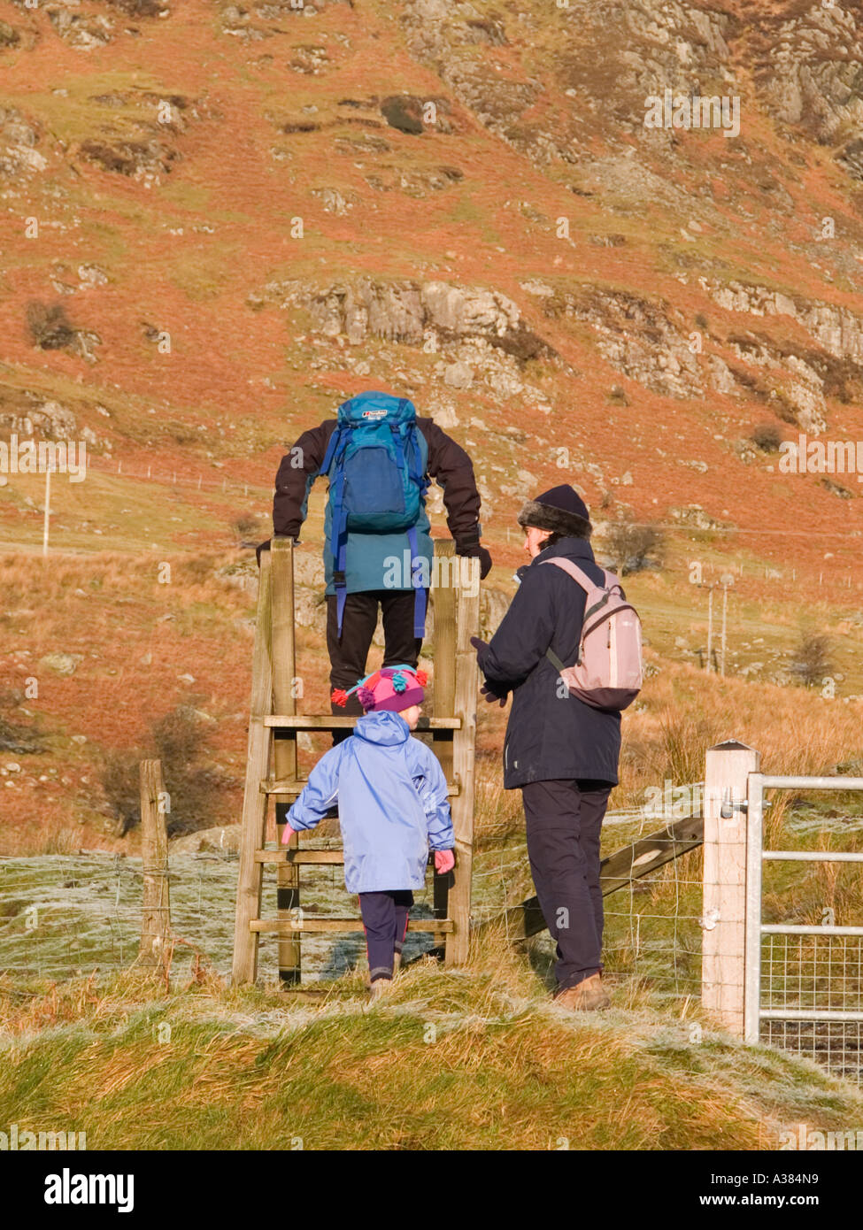 Woman climbing over fence hi-res stock photography and images - Alamy