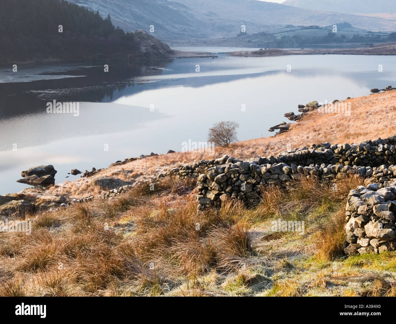 LLYNNAU MYMBYR lakes beyond stone wall in Snowdonia National Park near ...