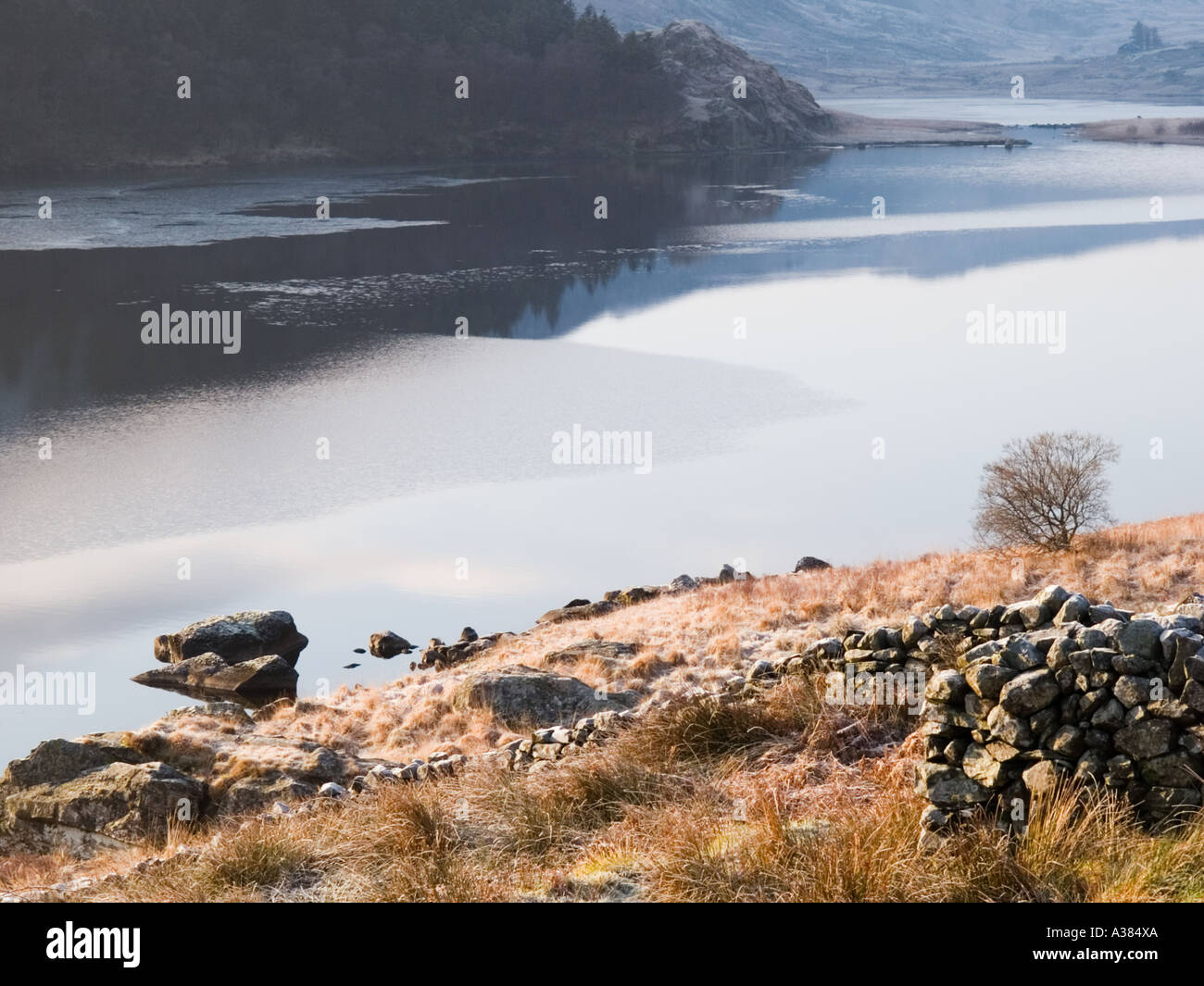 LLYNNAU MYMBYR LAKE beyond stone wall in Snowdonia National Park Capel ...