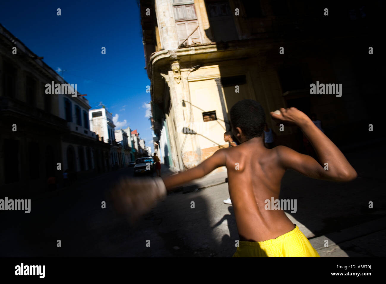 Cuban boy pitching in a game of street baseball Stock Photo - Alamy