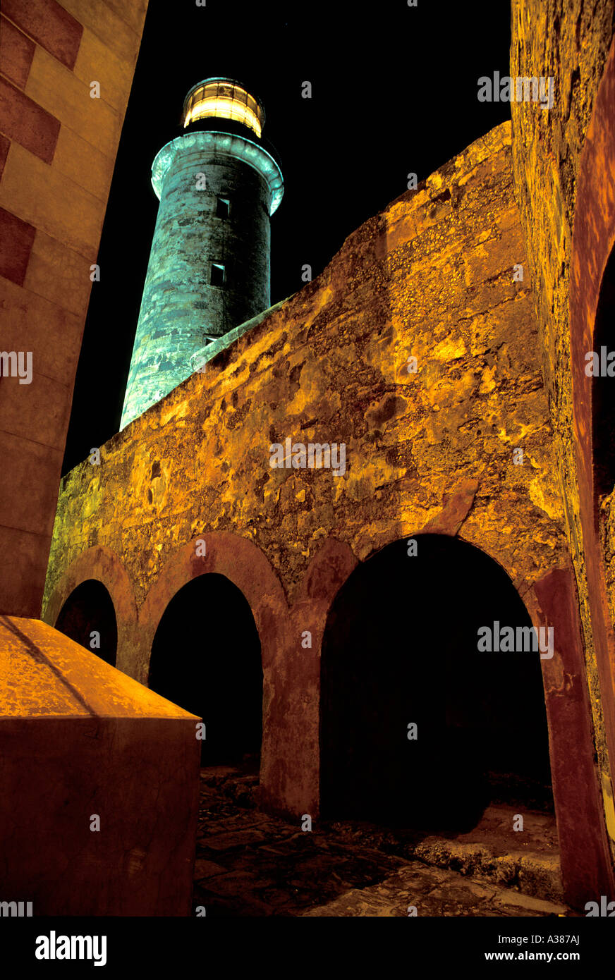 A view from inside El morro at night as it glows cyan and orange from ...