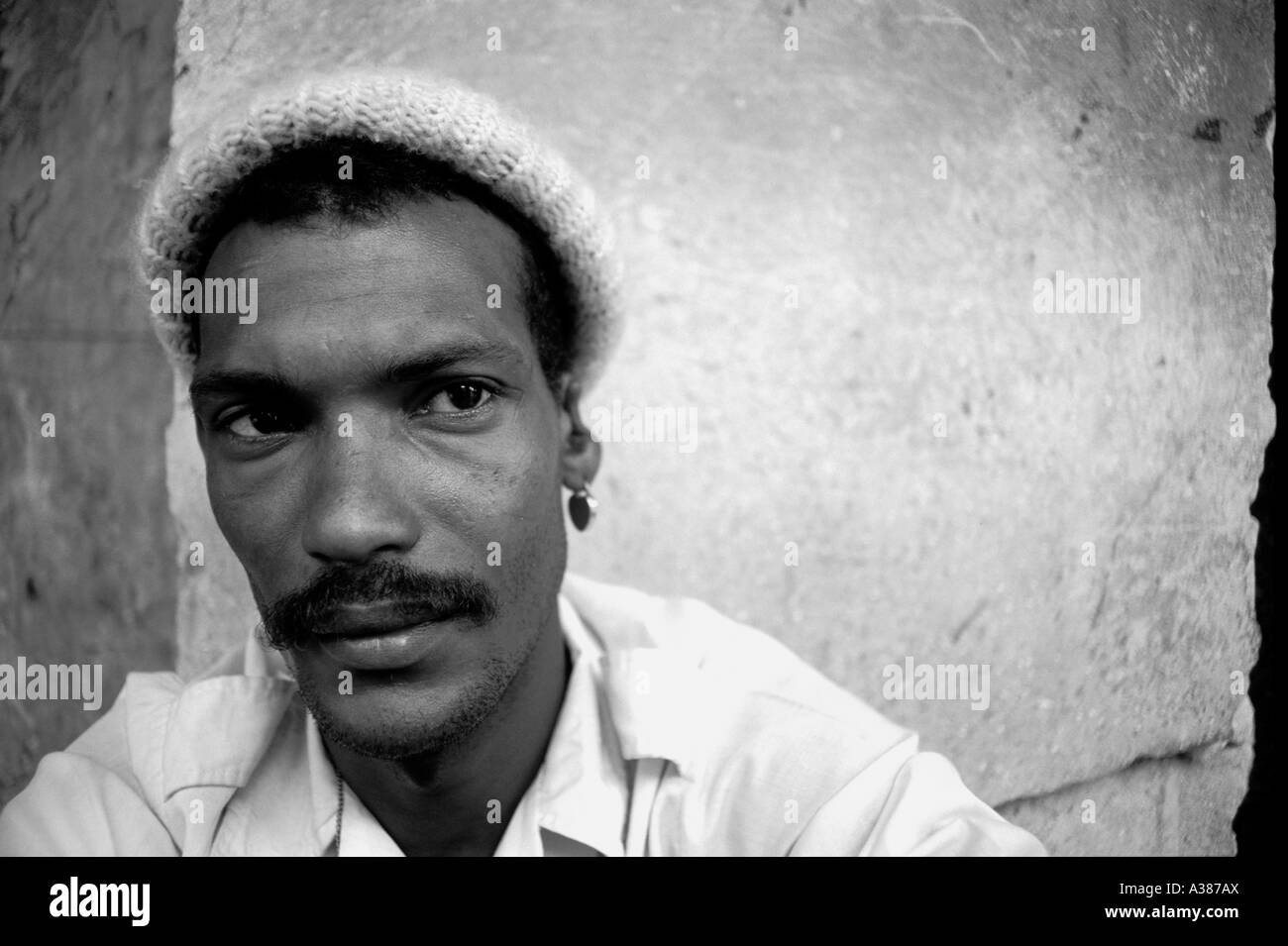 A Cuban man sits on a sidewalk in Havana selling trinkets Stock Photo ...