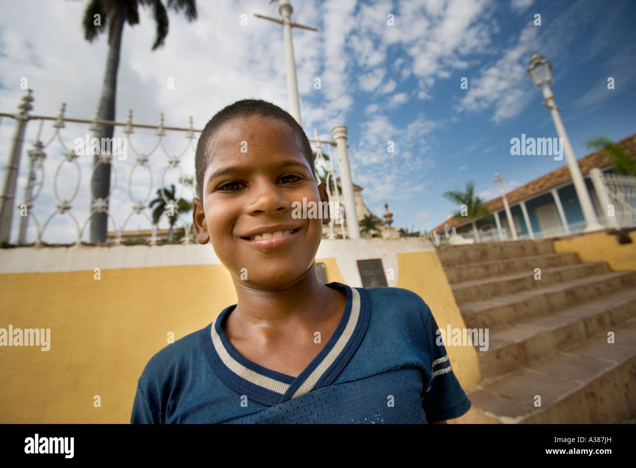 A cuban boy stands at the steps of Plaza Mayor Trinidad's historic town ...