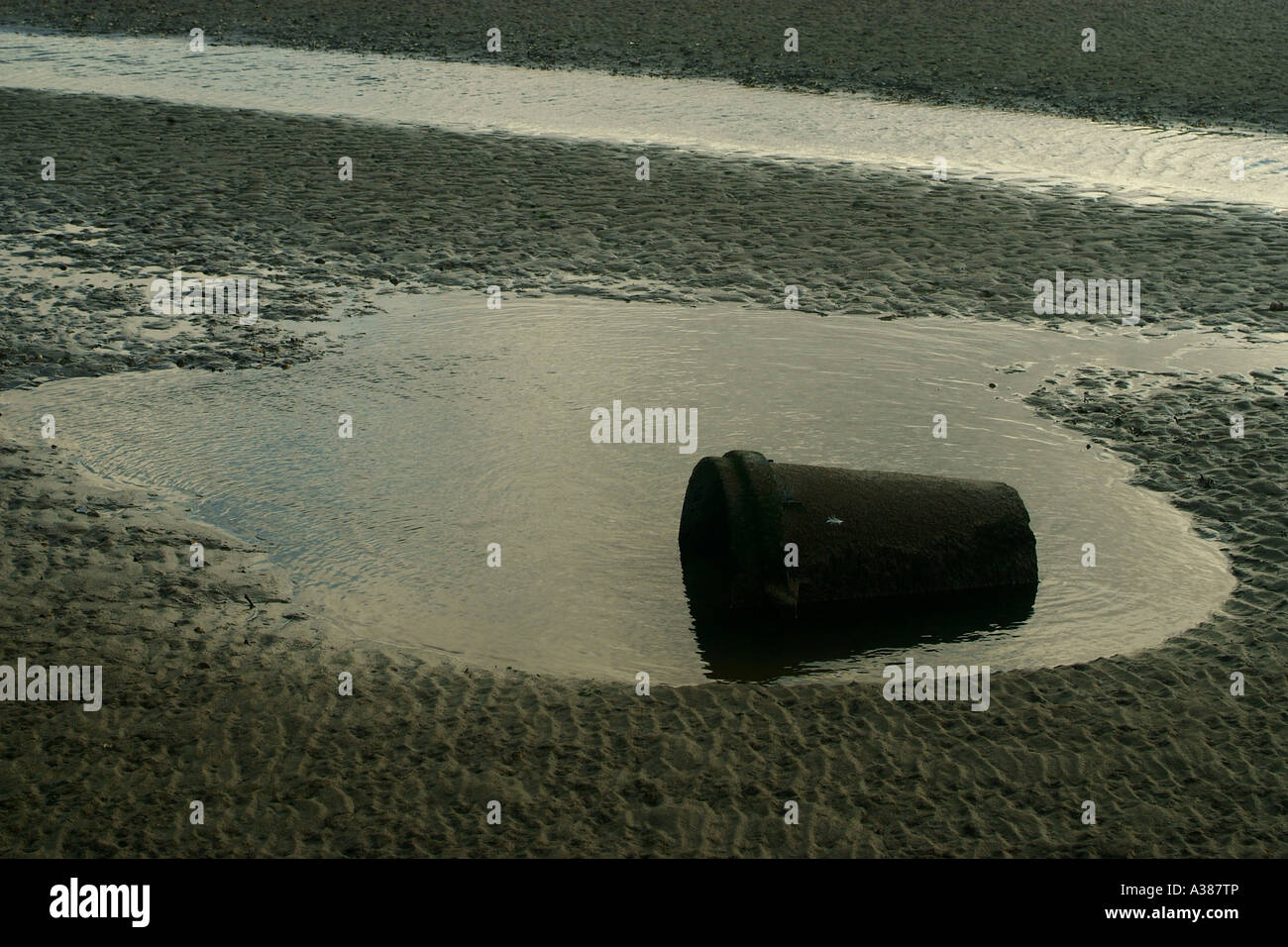 A bucket lies in a pool on a sandbank after the tide has gone out Stock ...