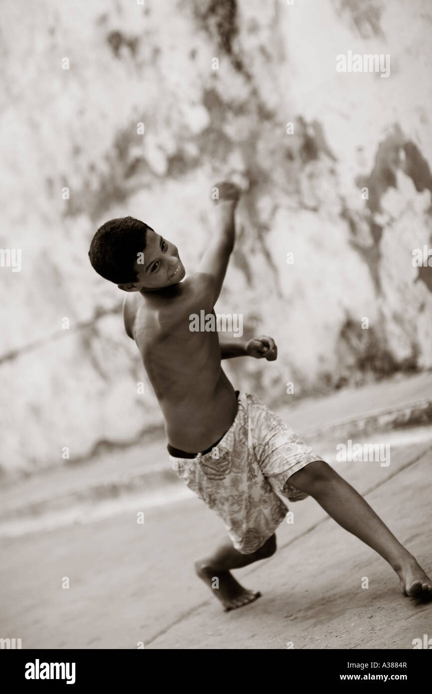 A young Cuban boy pitches in a game of street baseball Stock Photo - Alamy
