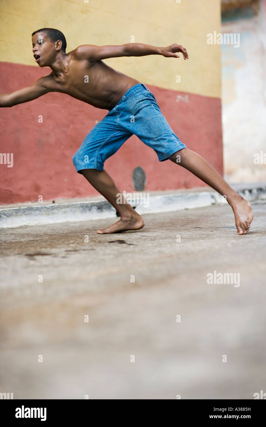 A Cuban boy reaches to catch a ball in a game of street baseball Stock ...