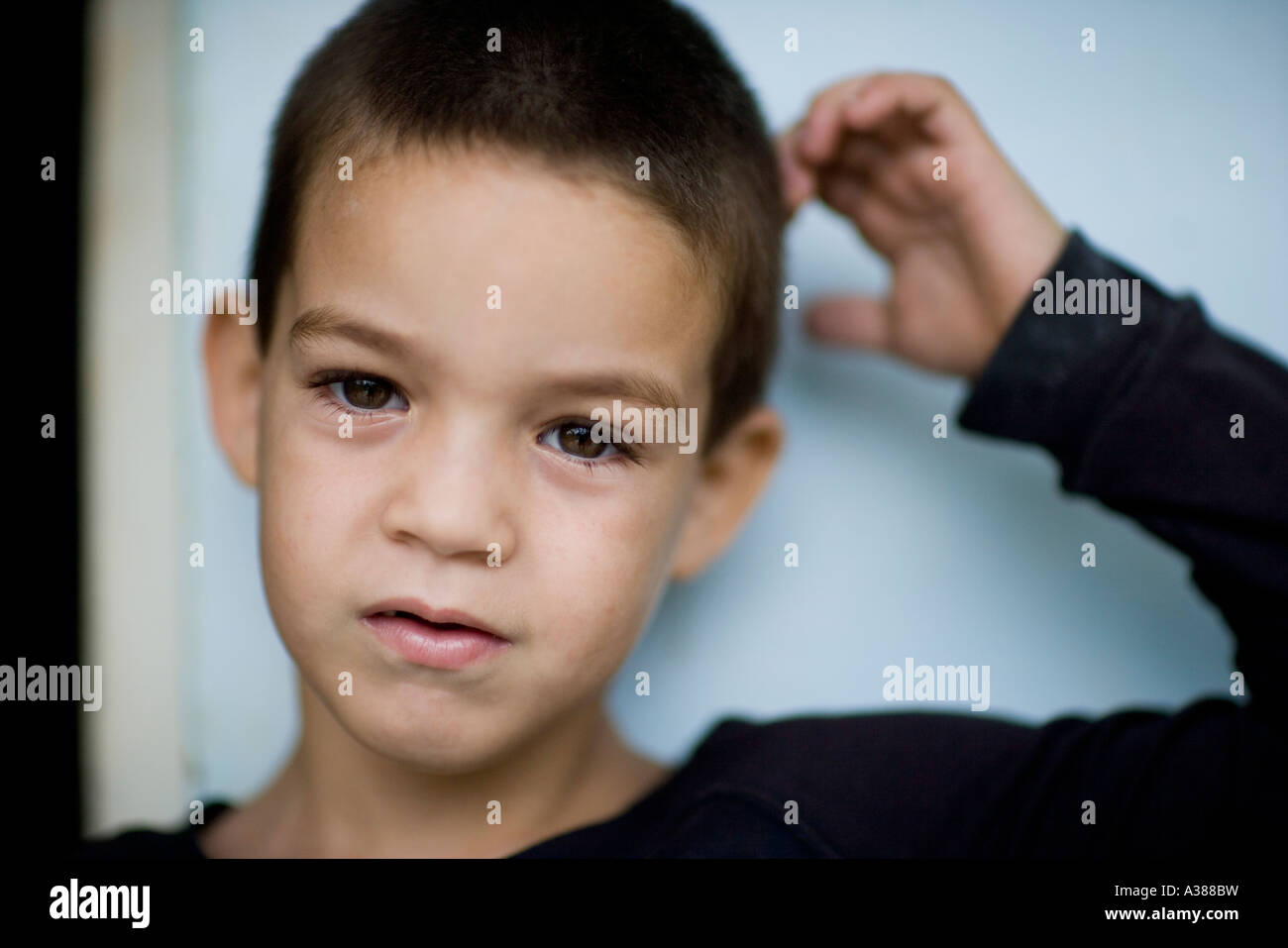 A young Cuban boy scratches his head Stock Photo - Alamy