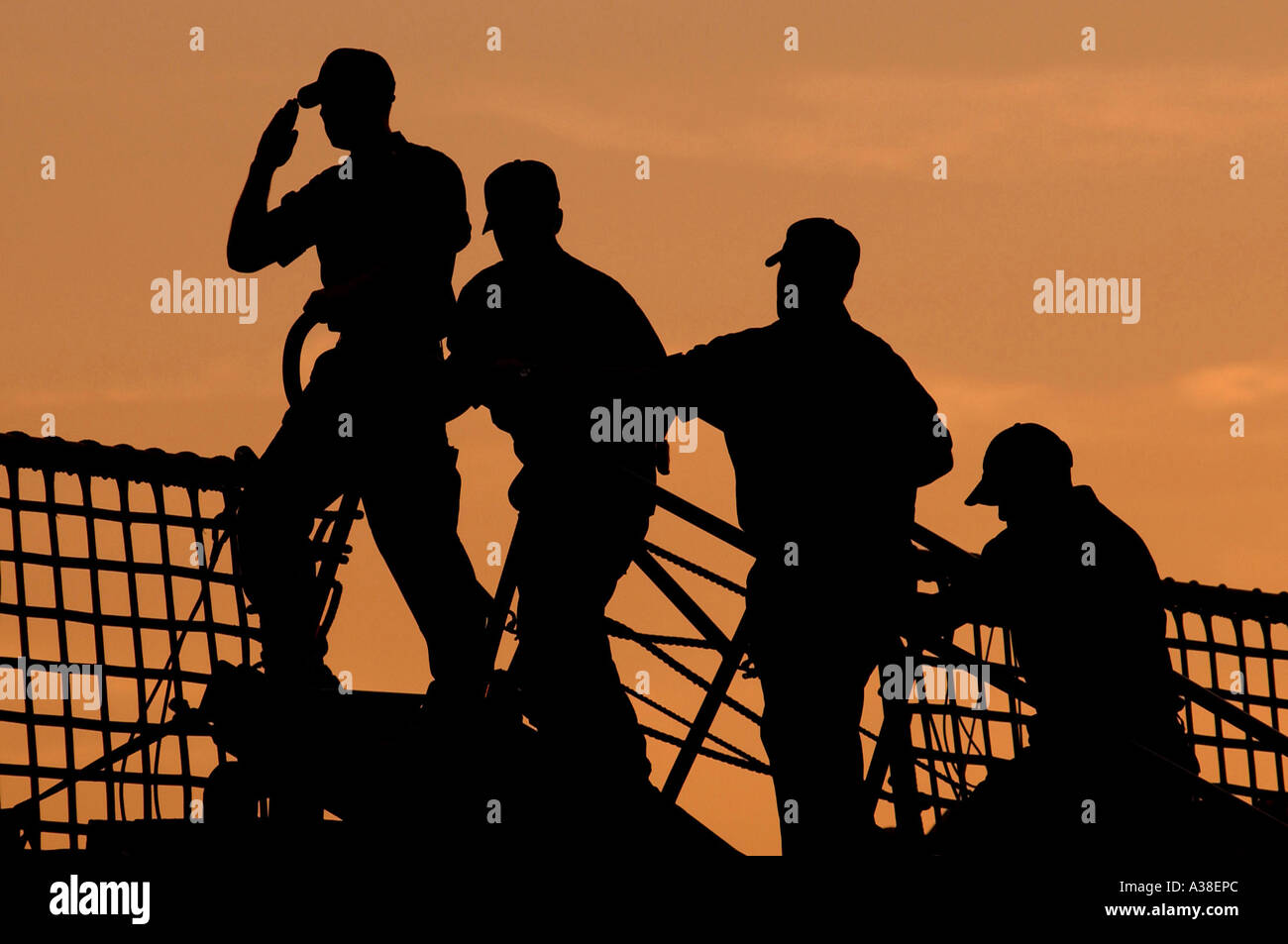 A U S Coast Guard crewman salutes as he steps aboard ship Stock Photo ...