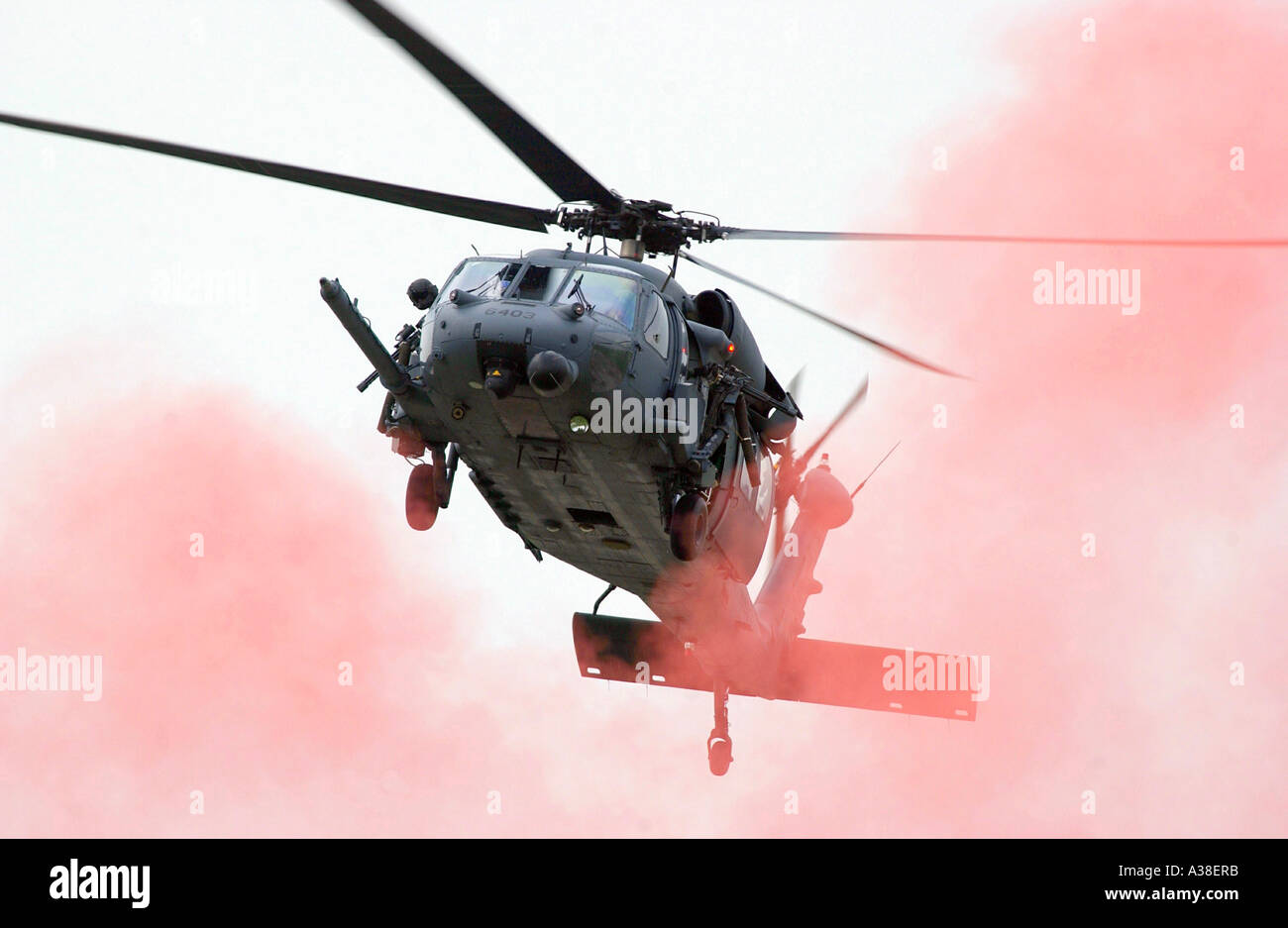 Military helicopter with red signal smoke Stock Photo - Alamy